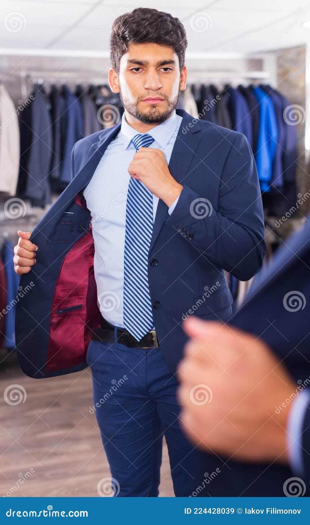 Man trying on jacket stock image. Image of lifestyle - 224428039