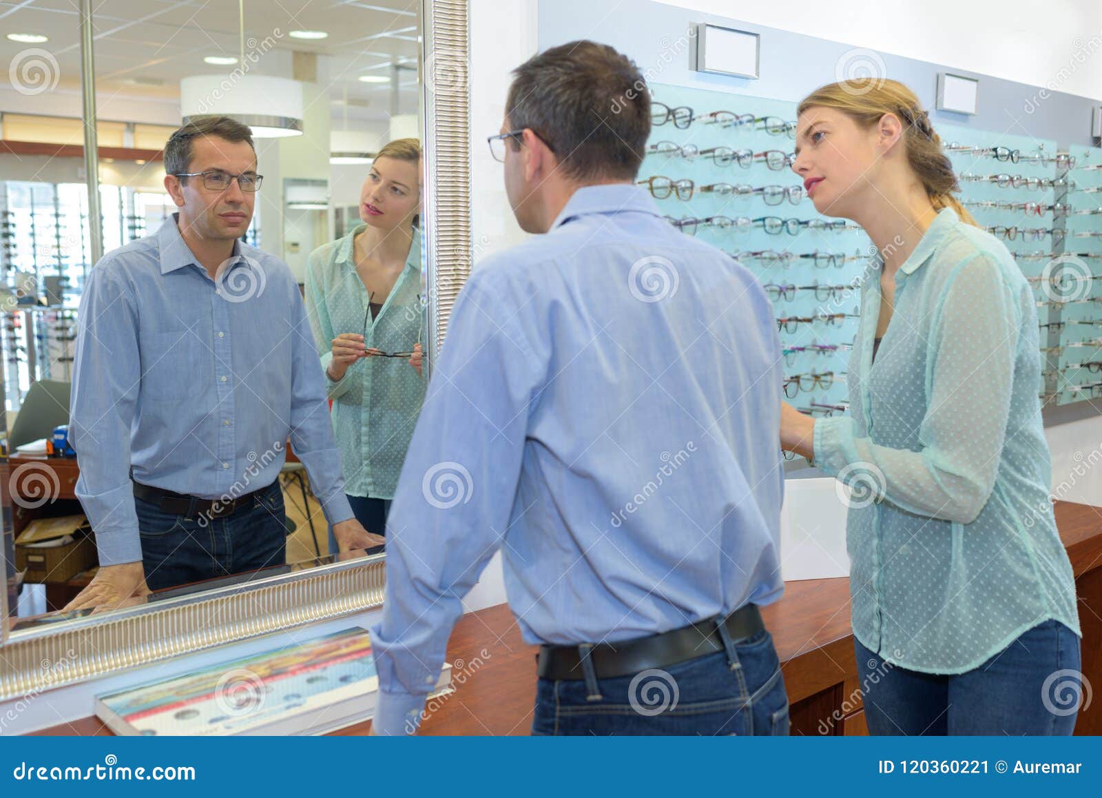 Man Trying on Spectacles and Looking in Mirror Stock Image - Image of ...