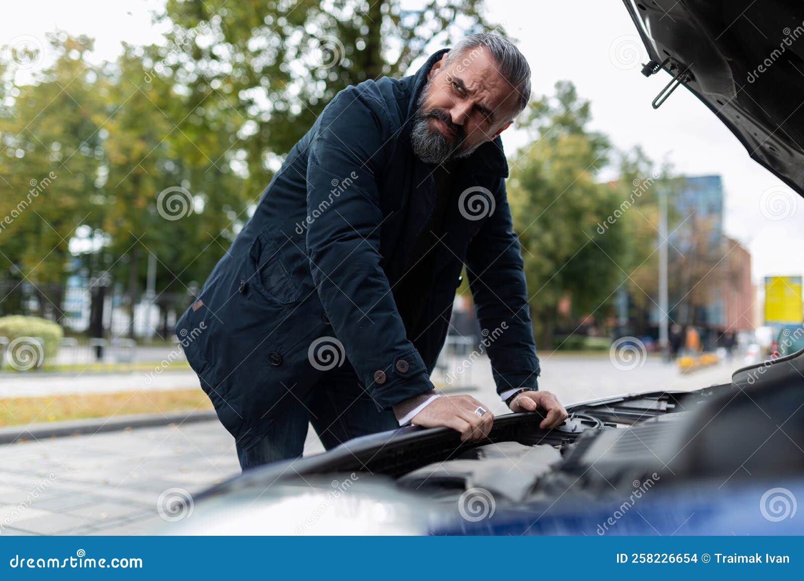 A Man is Trying To Figure Out the Breakdown of the Car Standing at the ... A Man is Trying To Figure Out the Breakdown of the Car Standing at the ...