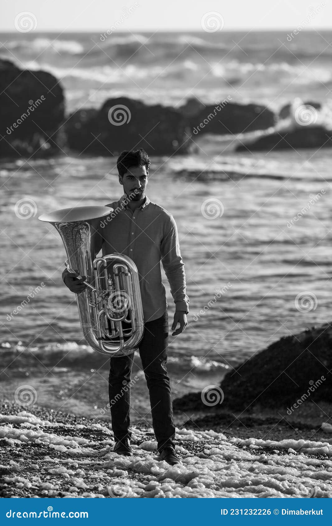 A Man with a Tuba on the Seashore. Black and White Photo. Stock Photo ...