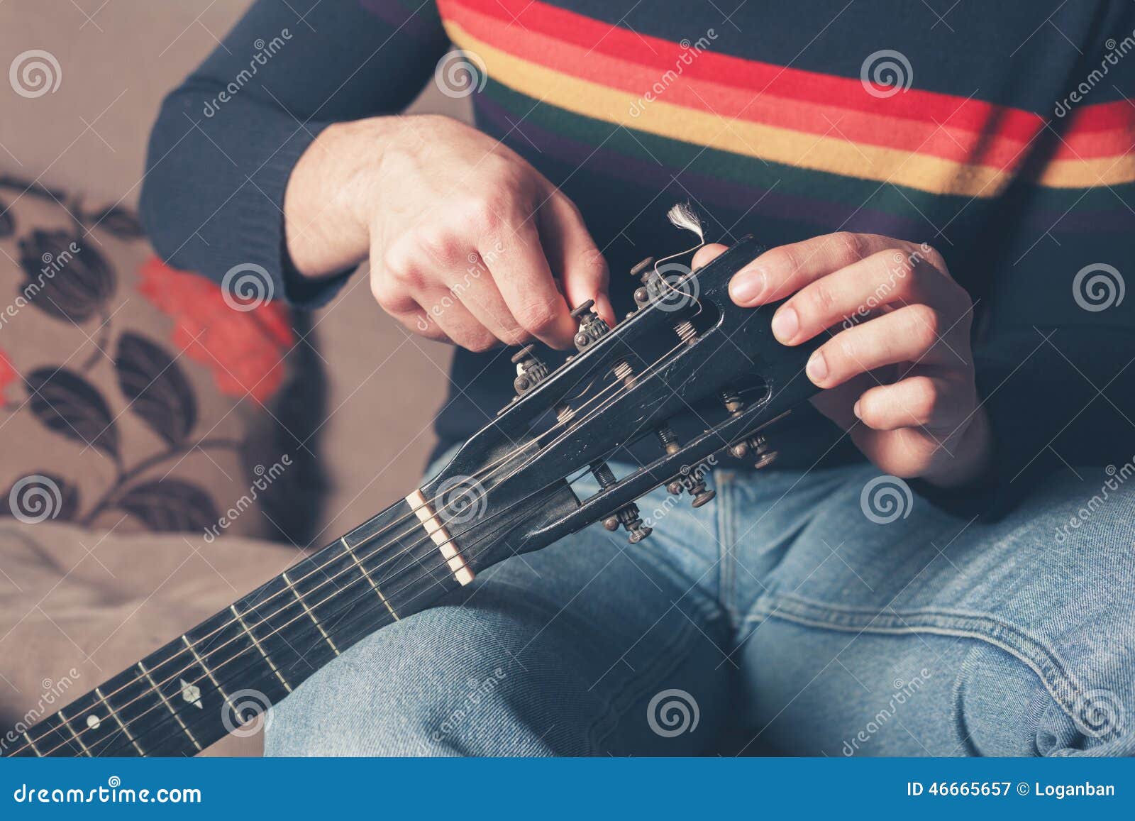 Man tuning guitar stock image. Image of house, people - 46665657