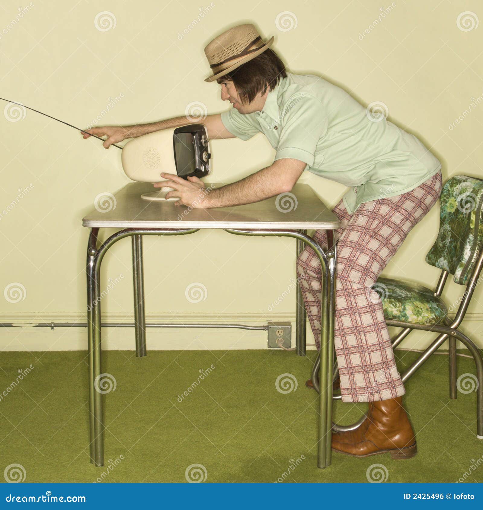 Man tuning in television. stock photo. Image of indoors - 2425496