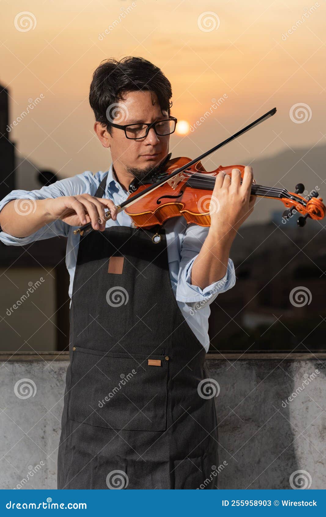 Man Tuning a Violin in a Terrace during Sunset Stock Image - Image of ...