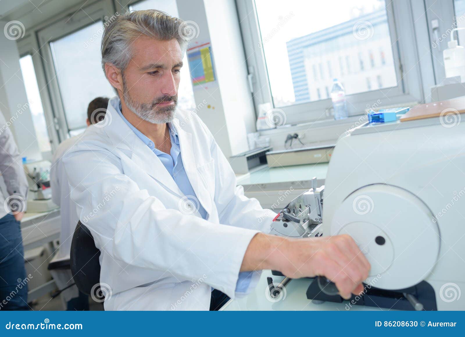 Man Turning Wheel on Side Machine Stock Photo - Image of wheel, aged ...