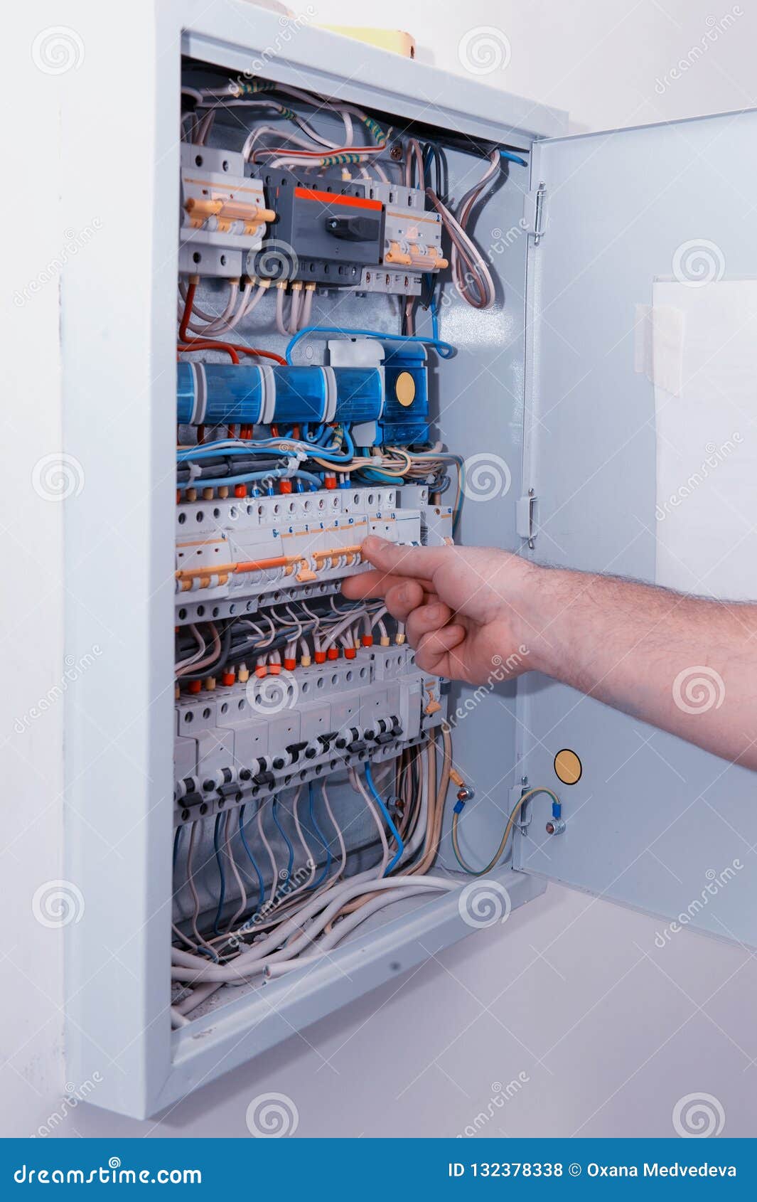 The Man Turns on the Electric Switch. Checking Electrical Equipment in ...