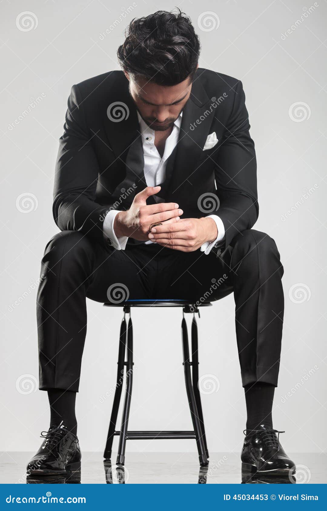 Man in Tuxedo Looking Down while Sitting on a Stool, Stock Image ...