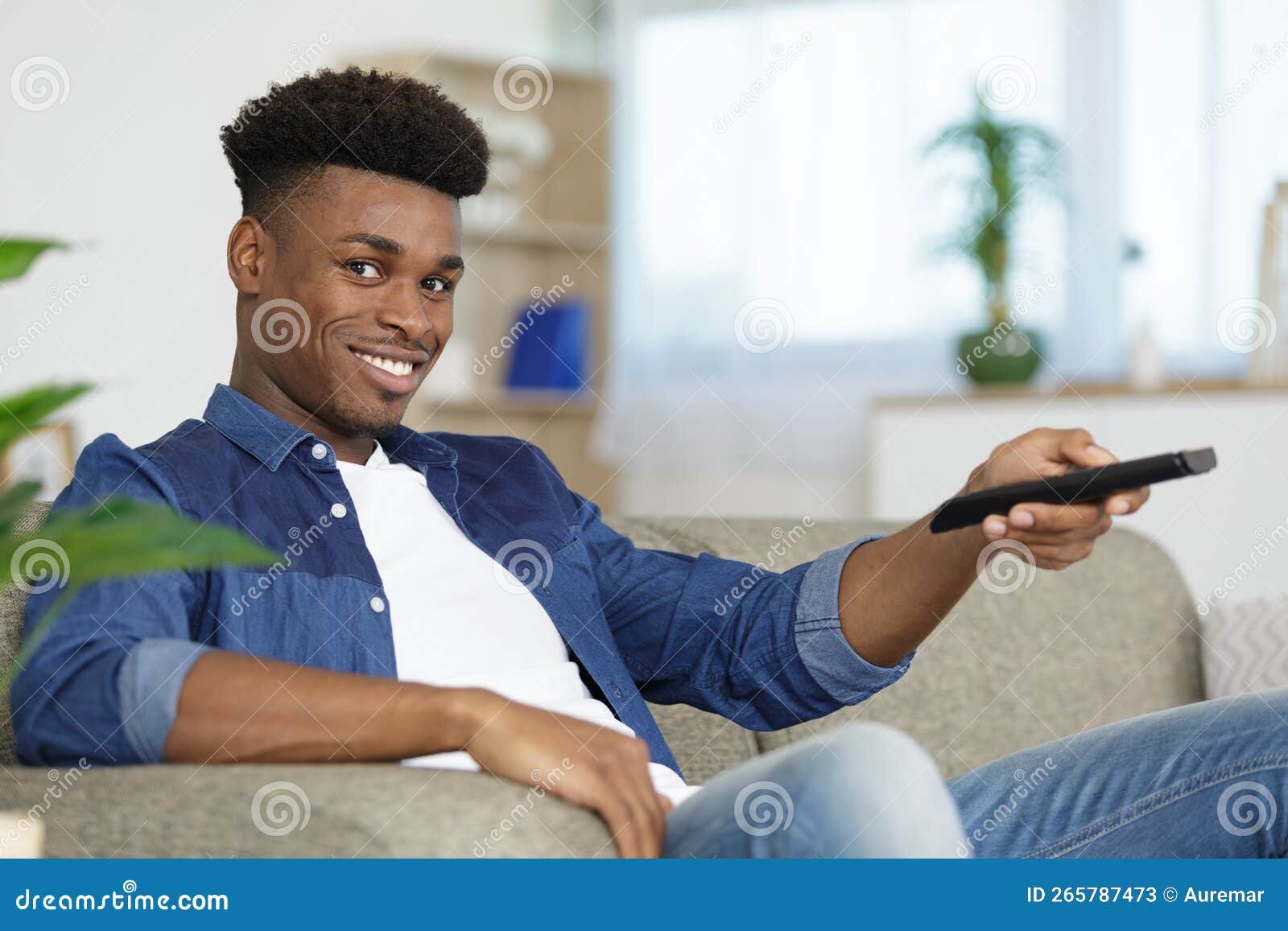 Man with tv remote stock image. Image of premiumvalue - 265787473