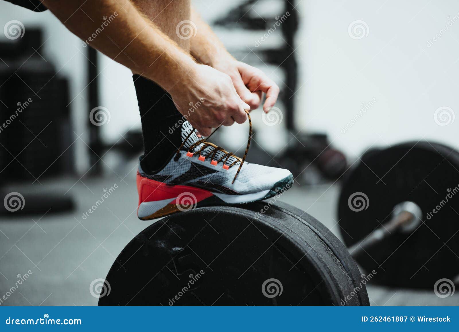Man Tying His Boot on the Barbell in the Gym Stock Image - Image of ...