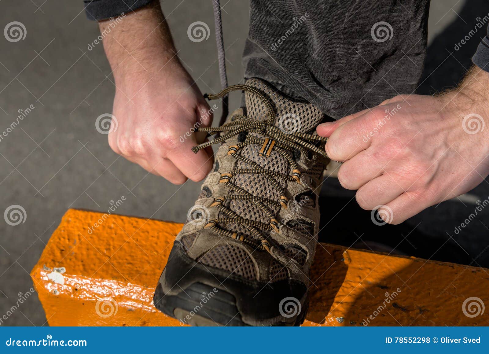 Man Tying Laces on the Ground Stock Photo - Image of foot, lace: 78552298