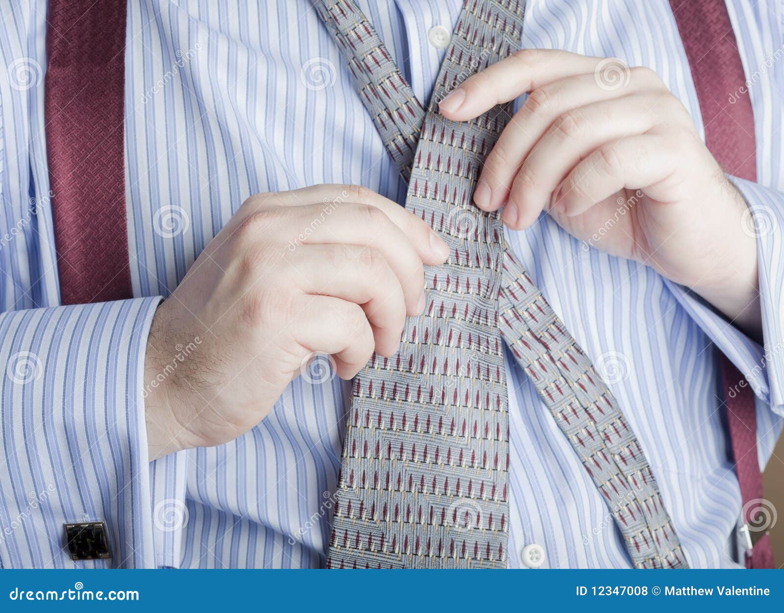 Man tying necktie stock photo. Image of dressing, suspenders - 12347008