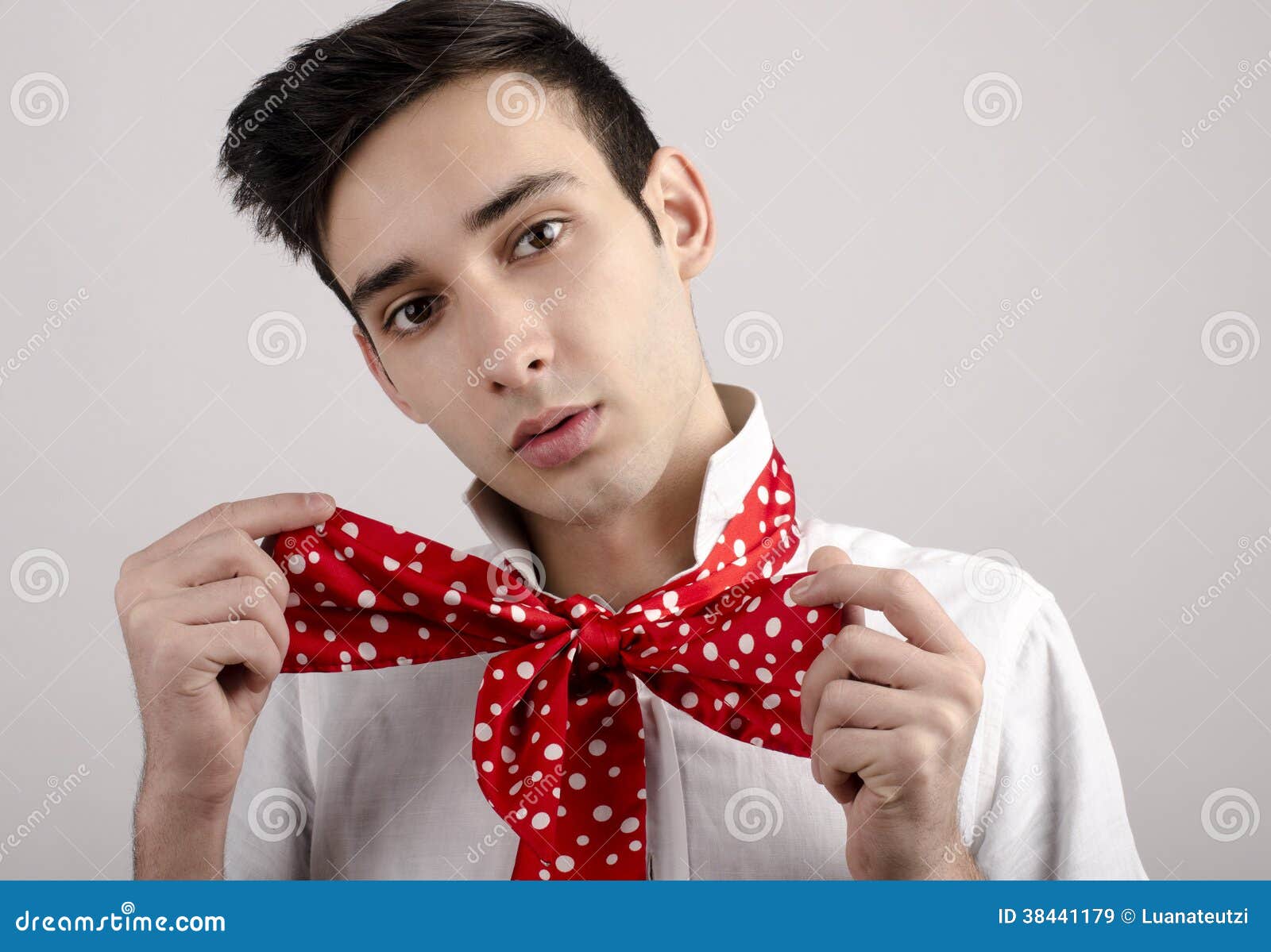 Man Tying a Red Scarf with Dots Around His Neck. Stock Image - Image of ...