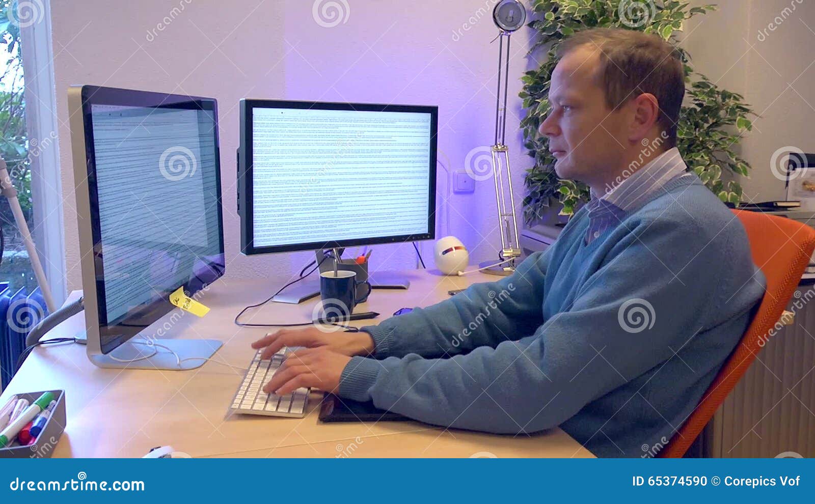 Man Typing Behind a Computer with Two Screens Stock Footage - Video of ...