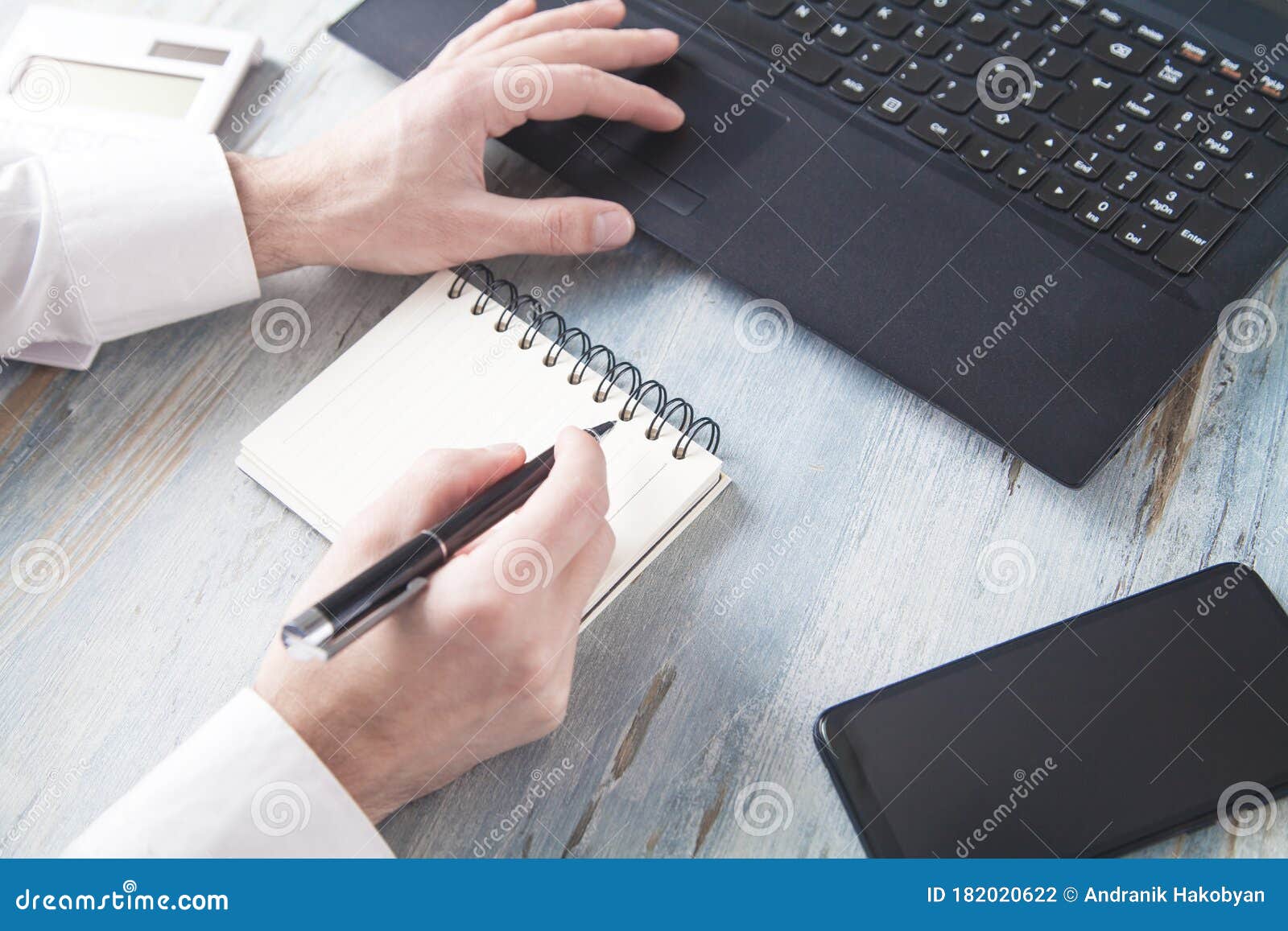 Man Typing in Keyboard and Writing on Notepad Stock Photo - Image of ...
