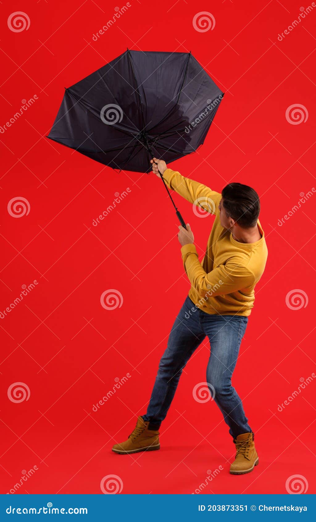 Man with Umbrella Caught in Gust of Wind on Red Background Stock Image ...
