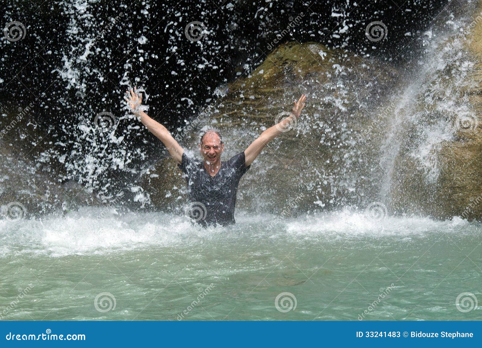 Man under waterfall flow stock image. Image of arms, relaxation - 33241483