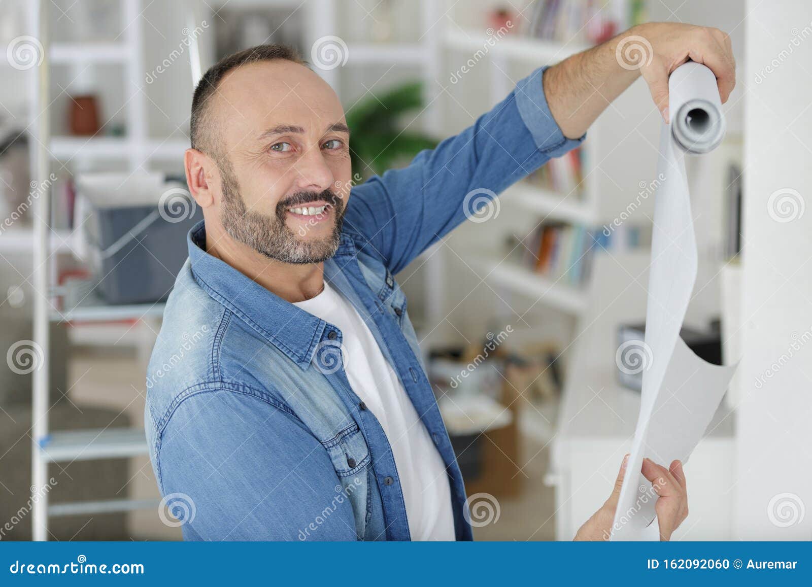 Man with Unfolded Roll Wallpaper Stock Photo - Image of male ...
