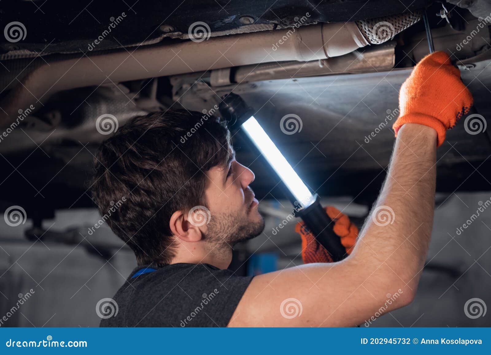 Machinist Holds a Flashlight and Inspects the Car Stock Photo - Image ...