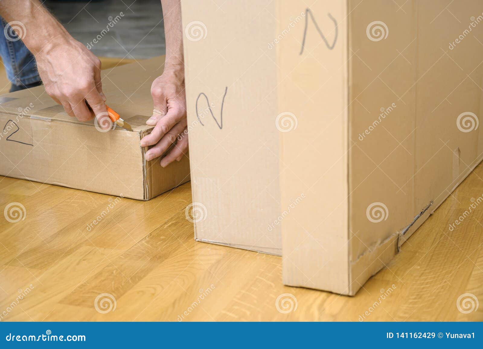 A Man is Unpacking the Cardboard Boxes Stock Image - Image of kitchen ...