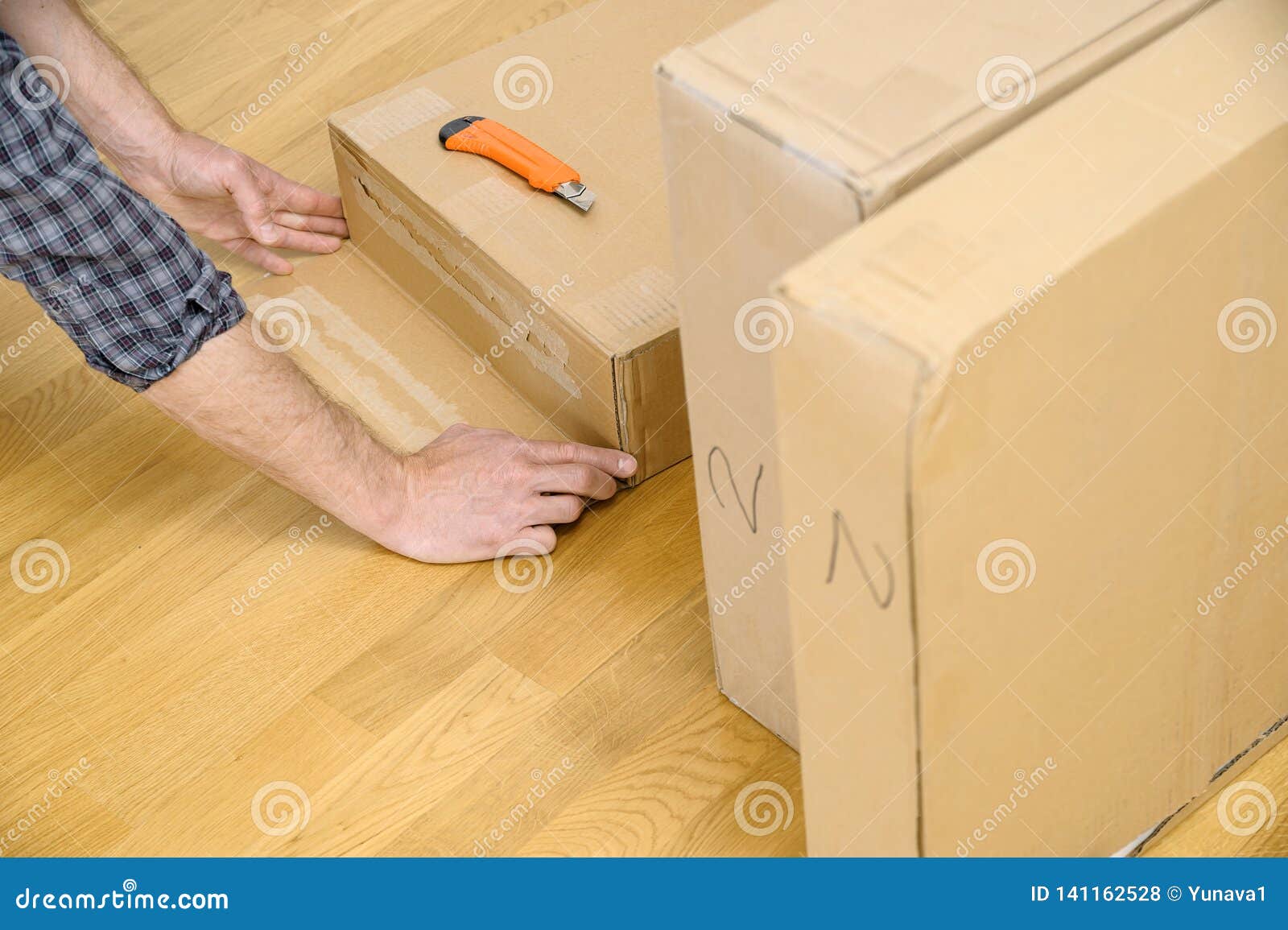 A Man is Unpacking the Cardboard Boxes Stock Photo - Image of order ...