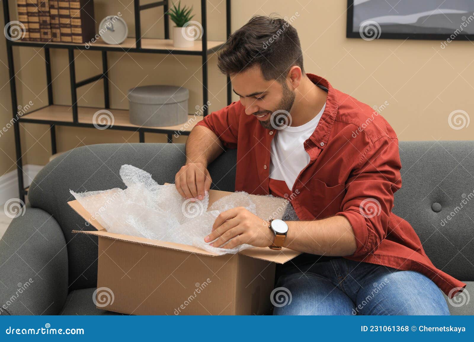 Man Unpacking Parcel at Home. Online Shopping Stock Photo - Image of ...