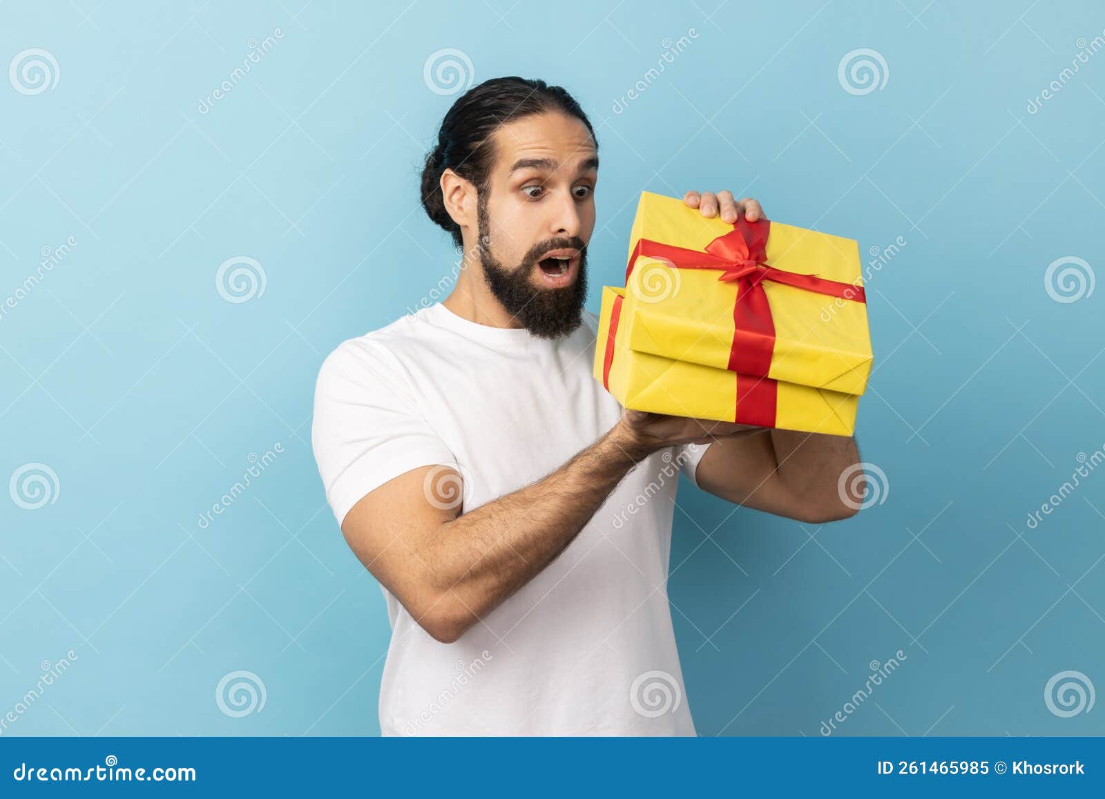Man Unpacking Present, Looking Inside Box with Shocked and Scared ...