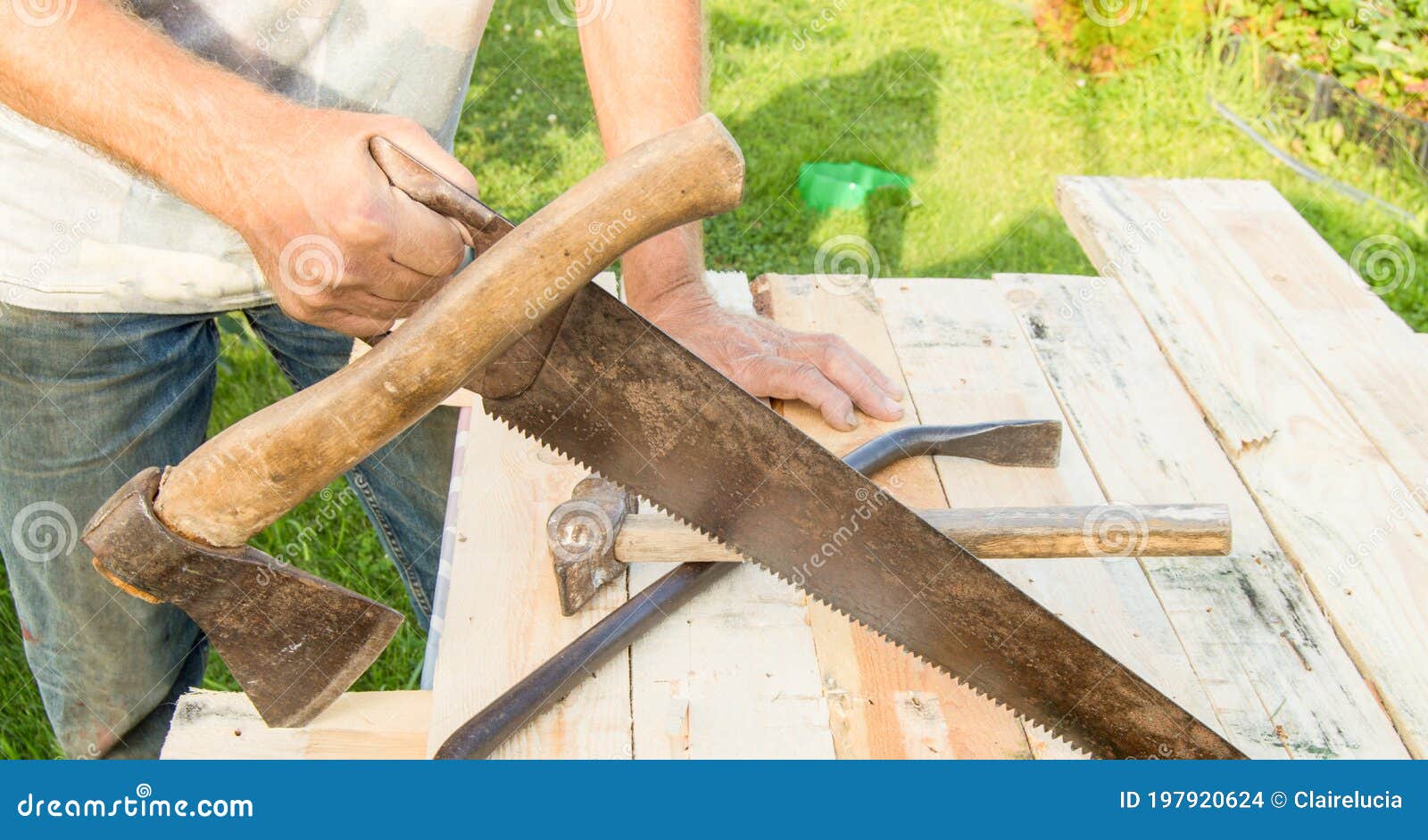 Man Uses a Hacksaw, a Hatchet, a Claw Hammer for Construction Work in ...