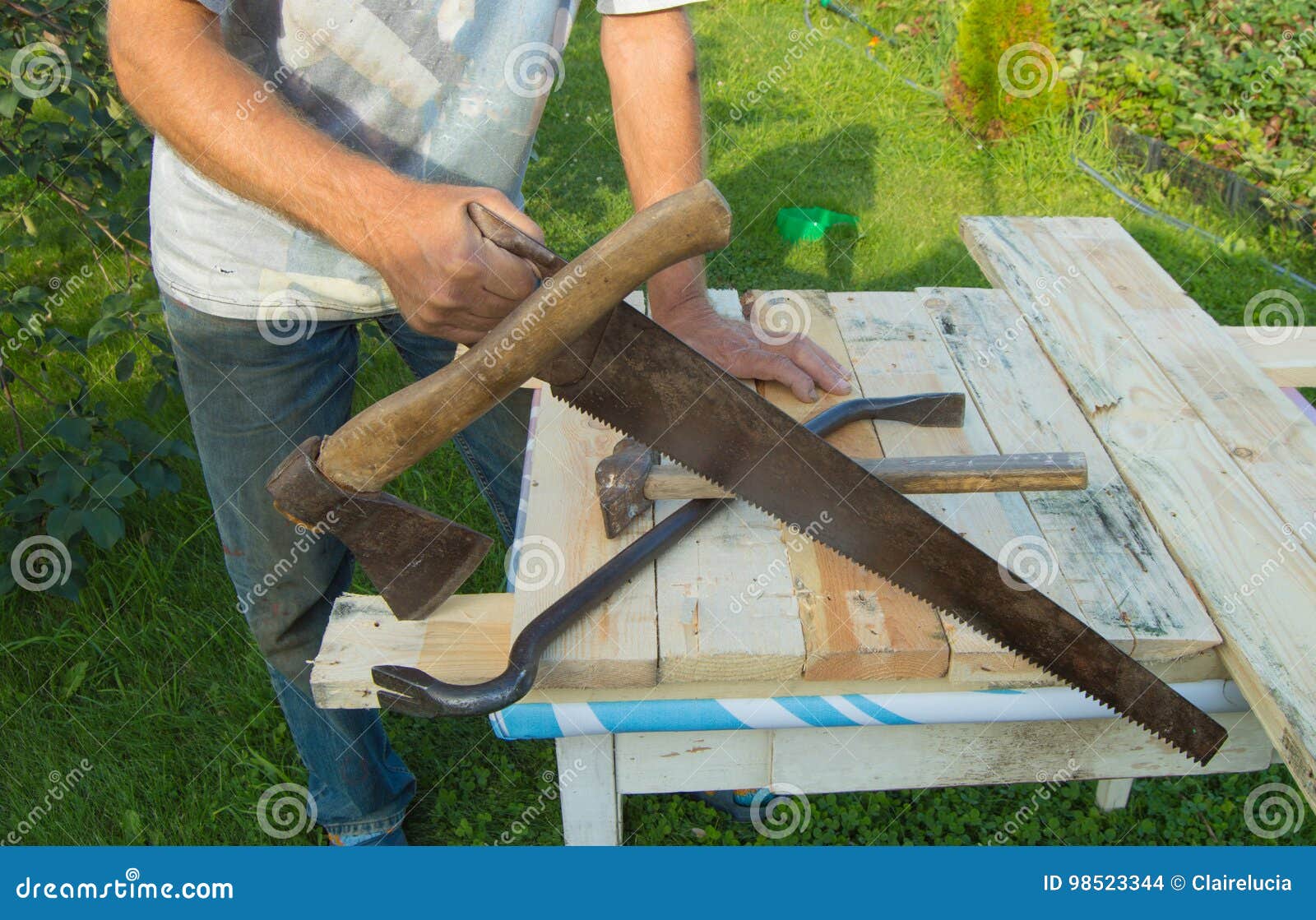 Man Uses a Hacksaw, a Hatchet, a Claw Hammer for Construction Work in ...