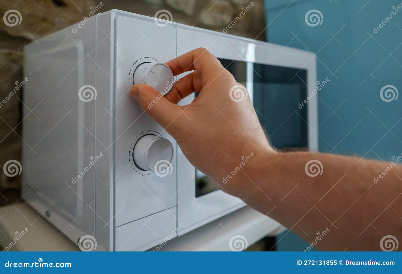 Man uses a microwave oven stock image. Image of invention - 272131855
