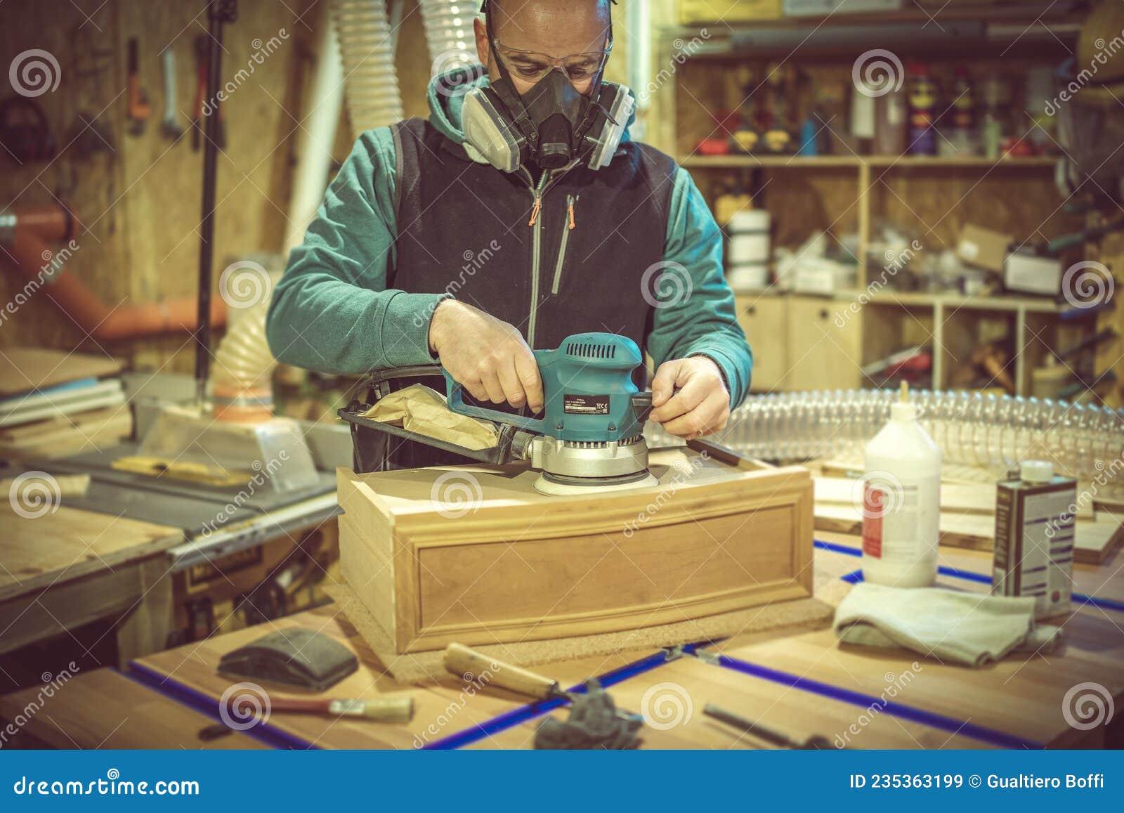 Man uses an orbital sander stock image. Image of craftsman - 235363199