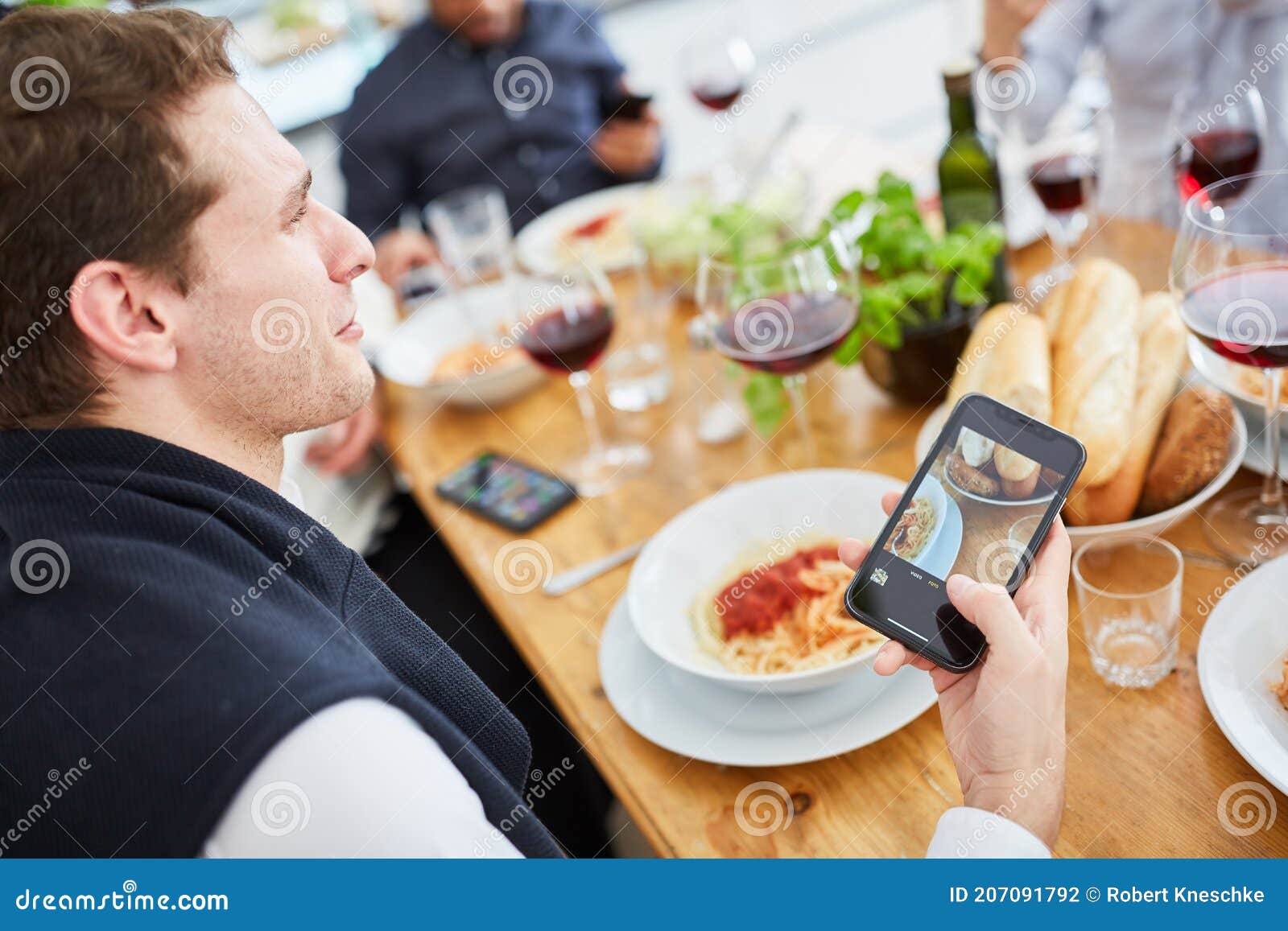 Man Uses Smartphone while Eating with Friends Stock Photo - Image of ...