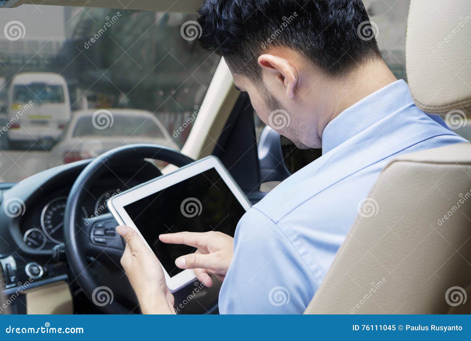 Man uses tablet in the car stock image. Image of business - 76111045