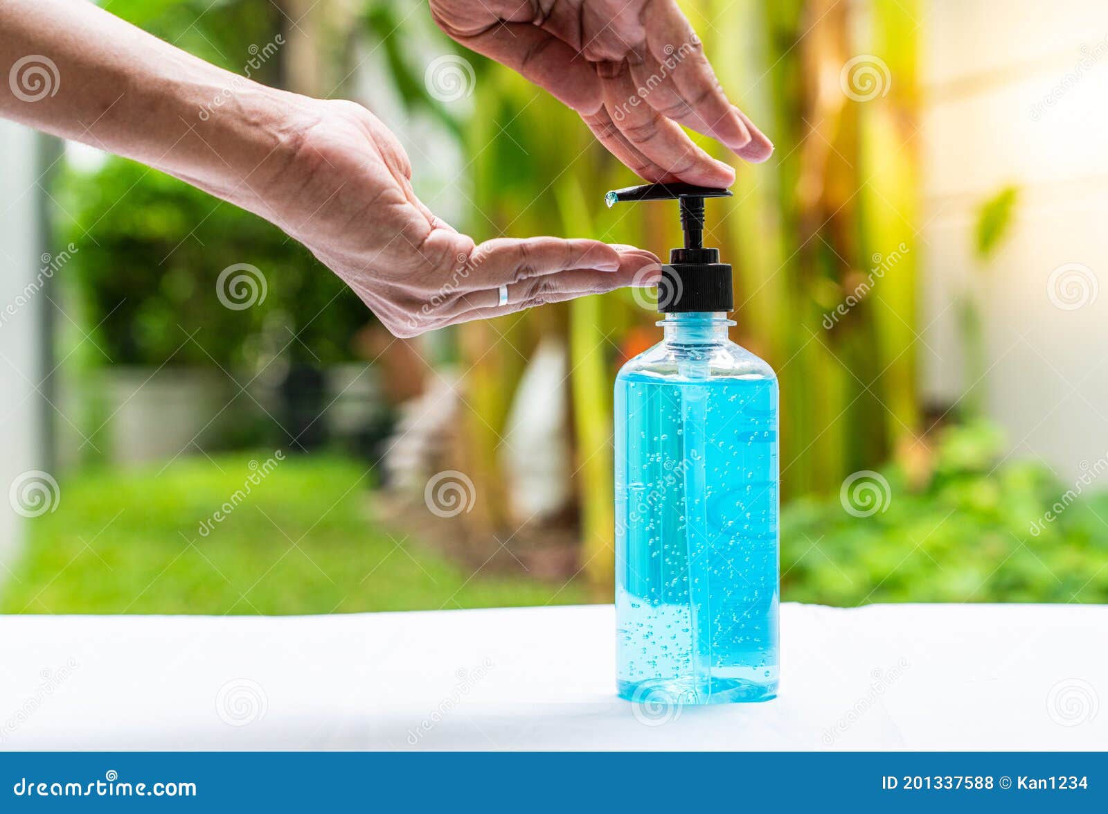 A Man Using Alcohol Hand Cleansing Gel To Clean His Hand Stock Photo ...