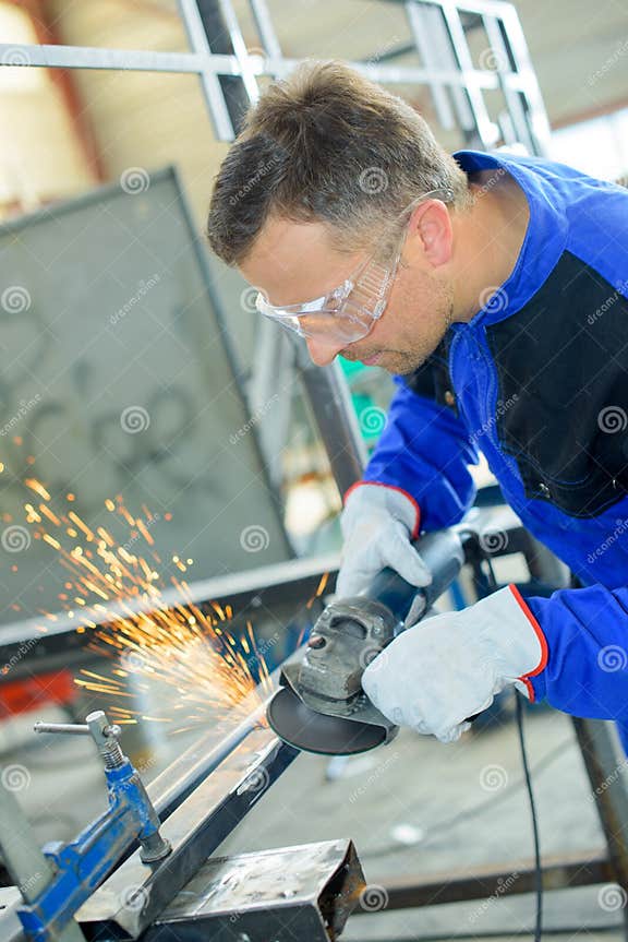 Man using angle grinder stock photo. Image of grind - 162092438