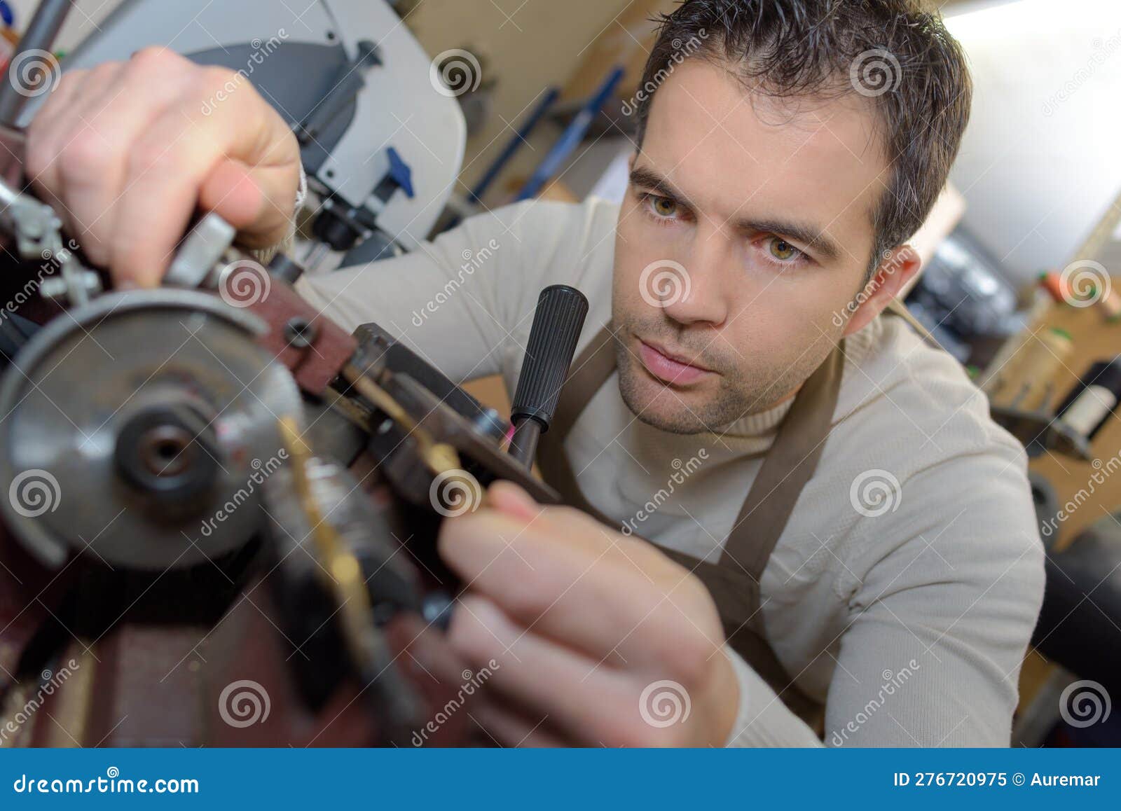 Man Using Bench Mounted Grinder Stock Image - Image of work, person ...