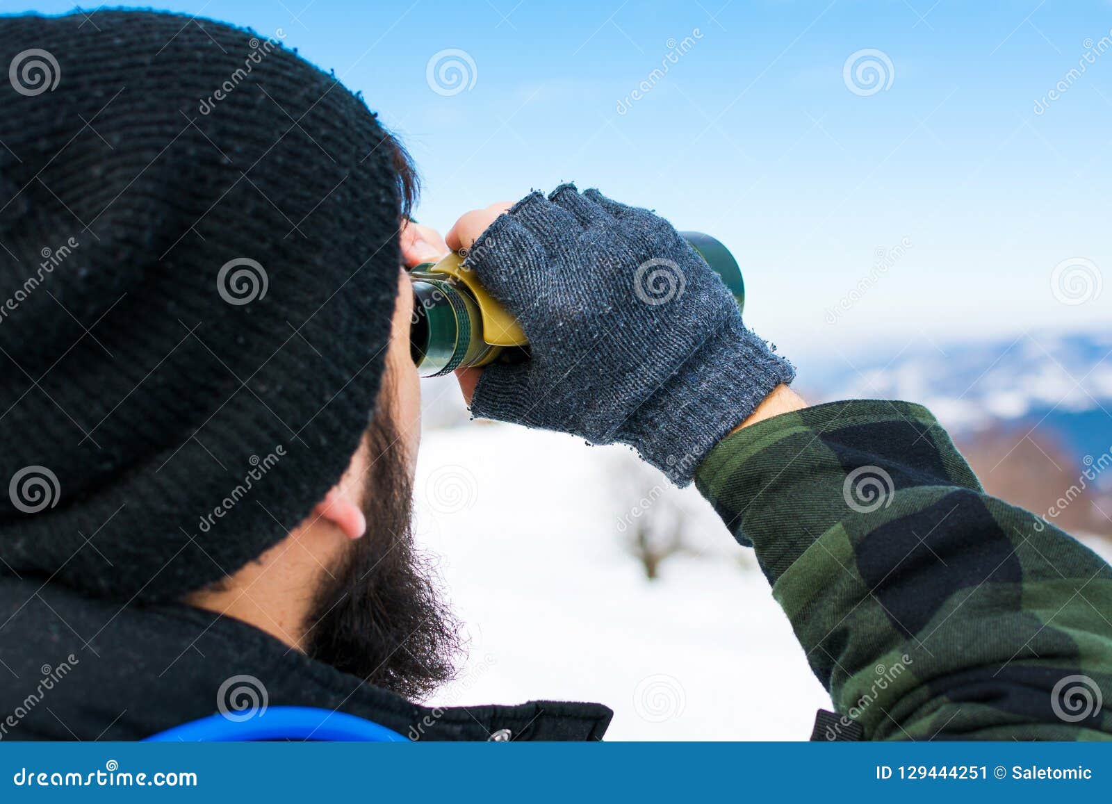 Man Using Binoculars on Snow Covered Mountain Stock Image - Image of ...