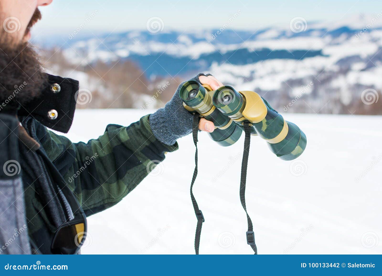 Man Using Binoculars on Snow Covered Mountain Stock Photo - Image of ...