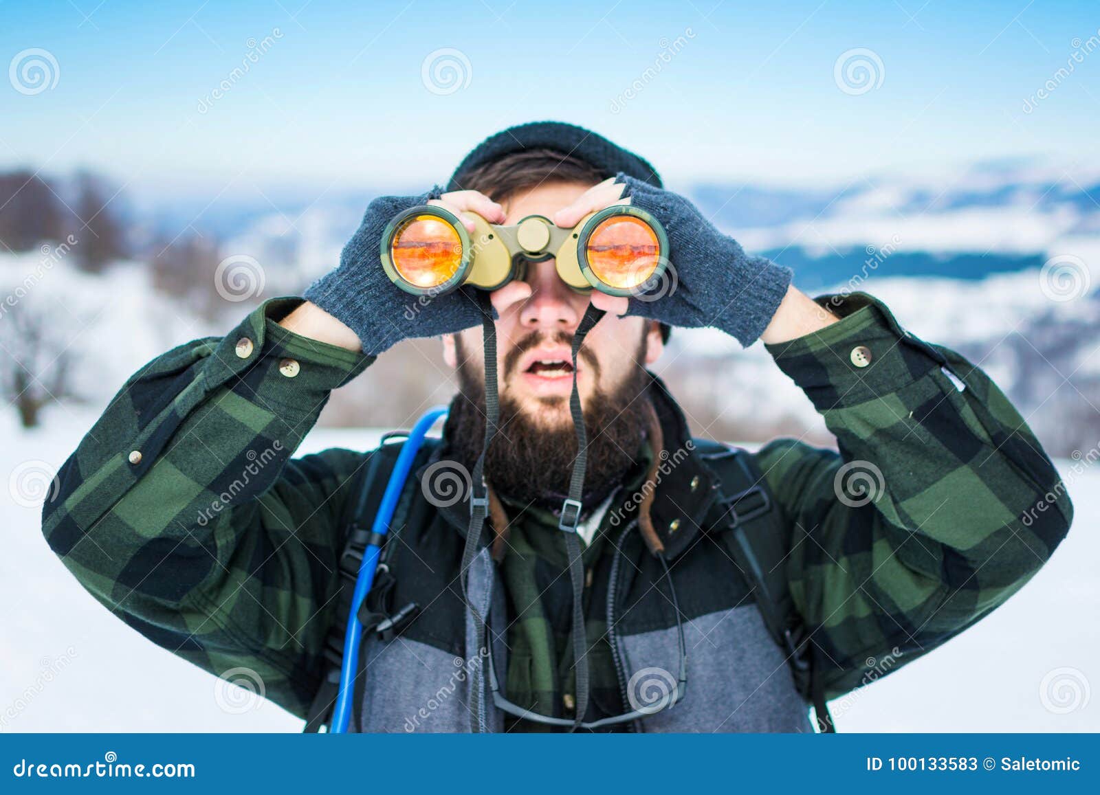 Man Using Binoculars on Snow Covered Mountain Stock Image - Image of ...