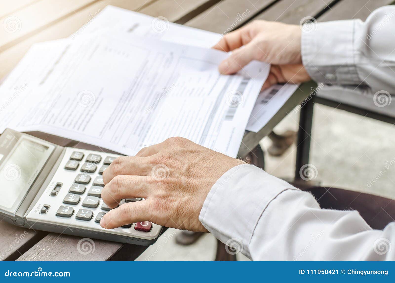 Man Using Calculator and Thinking about Cost with Paying Bills Stock ...