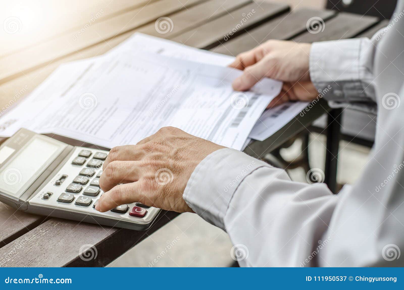 Man Using Calculator and Thinking about Cost with Paying Bills Stock ...