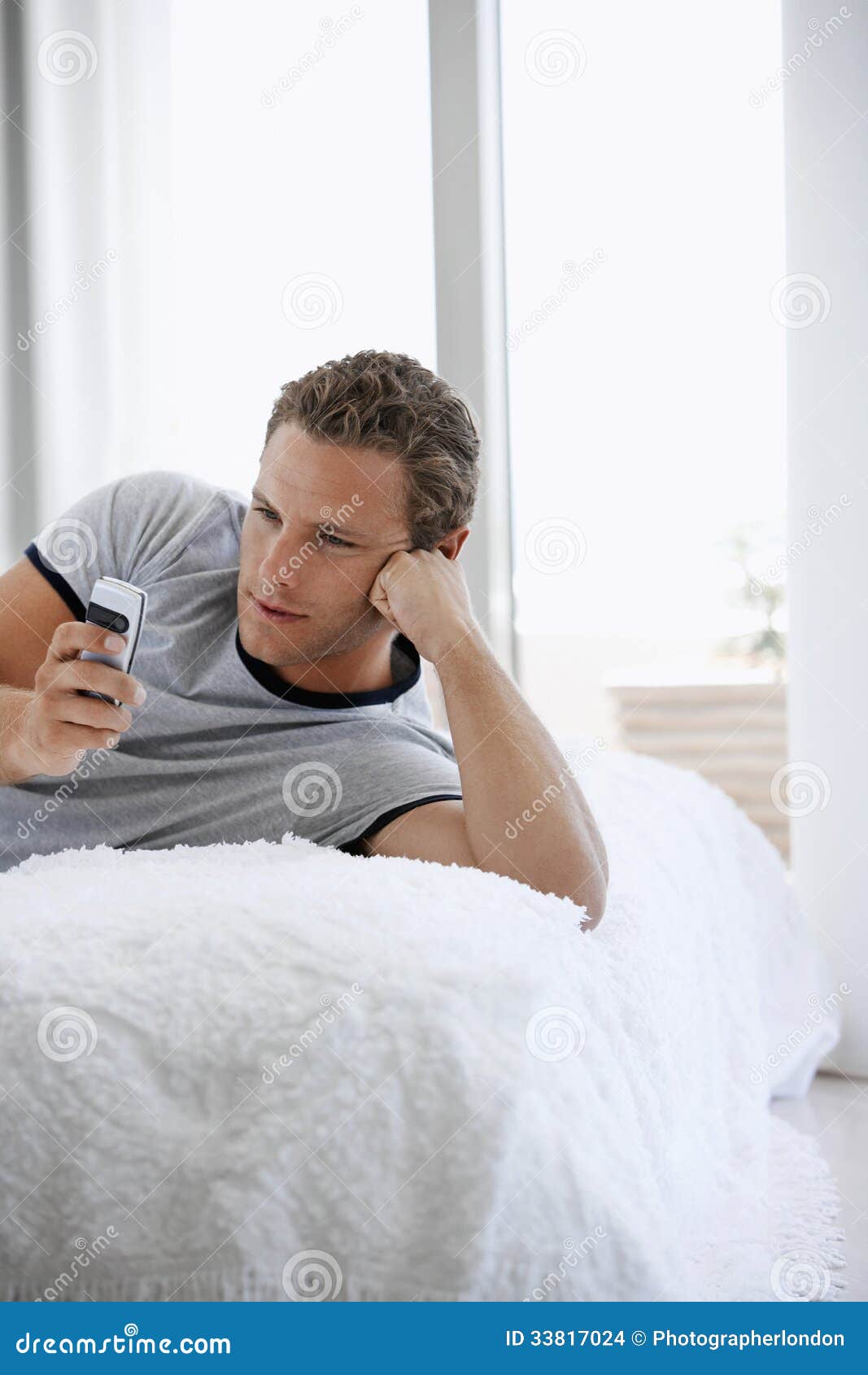 Man Using Cell Phone in Bed Stock Photo - Image of comfortable ...