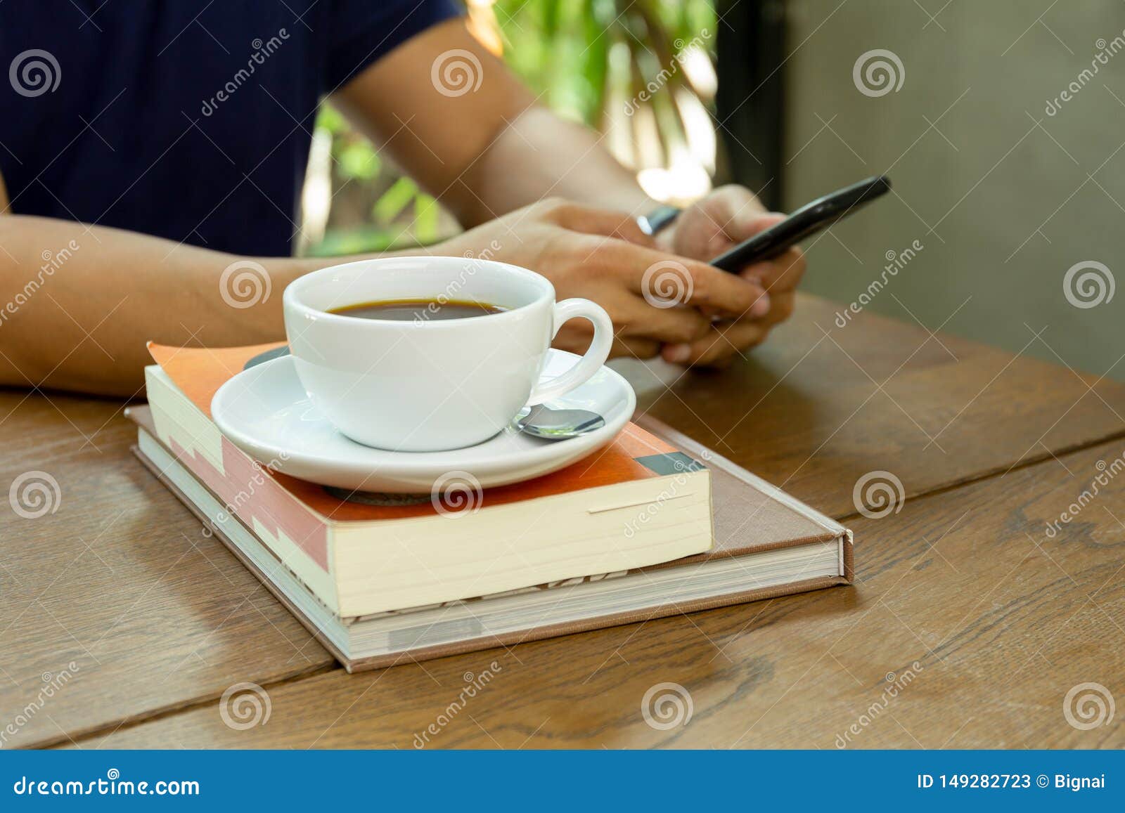 Man Using Cell Phone with Cup of Coffee on Table in Cafe. Stock Image ...