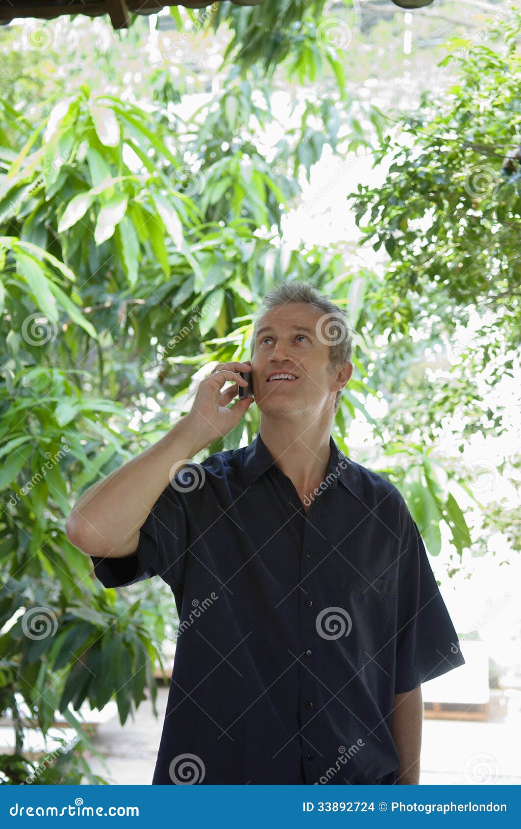 Man Using Cell Phone Outdoors Stock Photo - Image of east, middle: 33892724