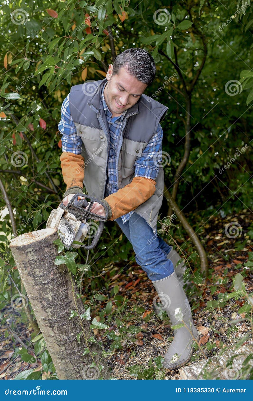 Man using a chainsaw stock photo. Image of protection - 118385330