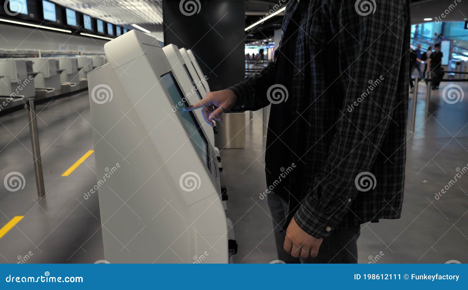 Man Using the Check-in Machine at the Airport Getting the Boarding Pass ...