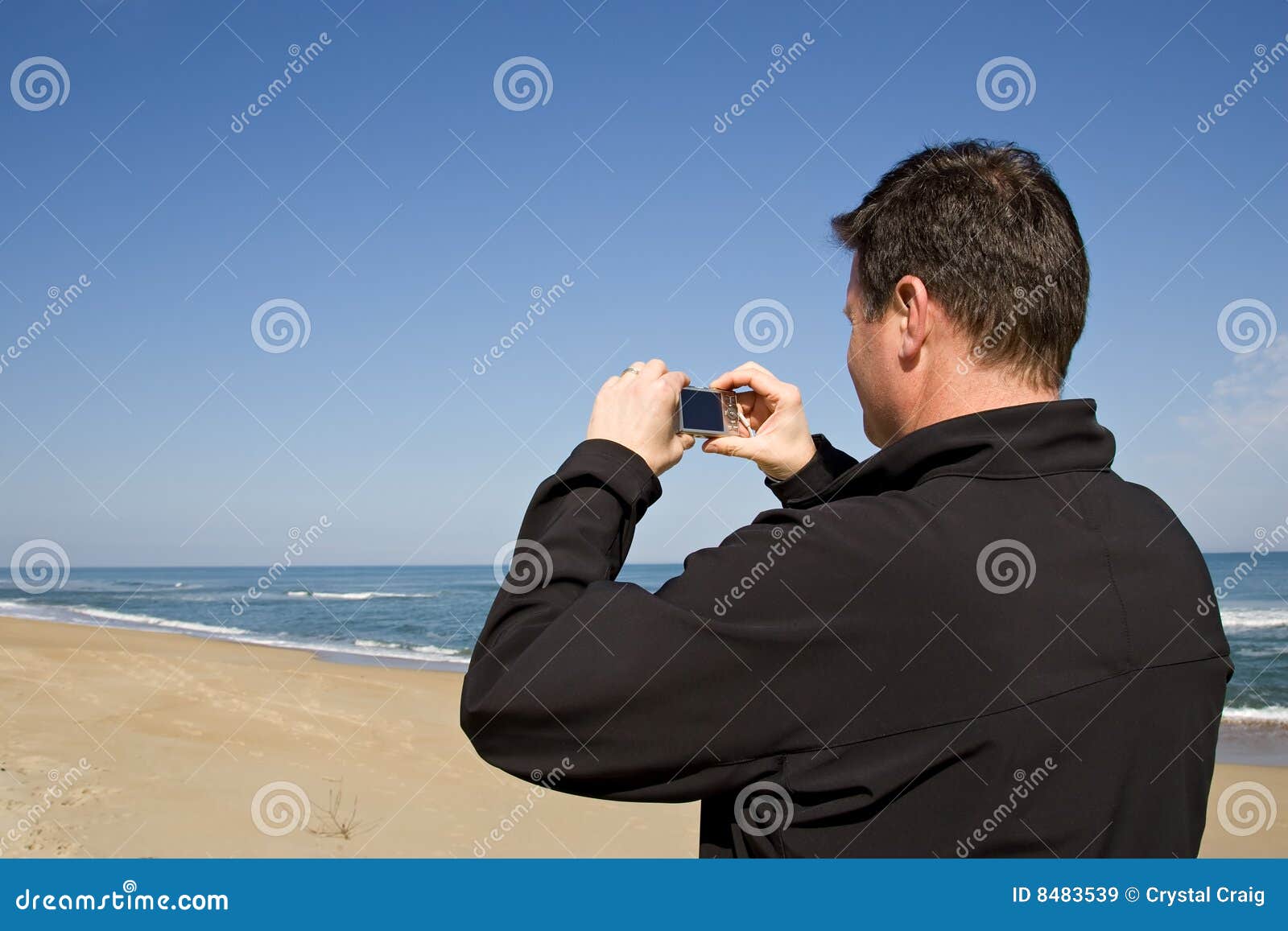 Man using compact camera stock image. Image of sand, black - 8483539