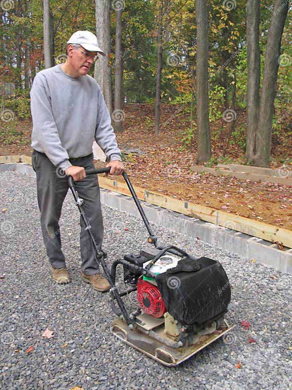 Man Using Compactor To Pack Stone Stock Image - Image of outdoors ...
