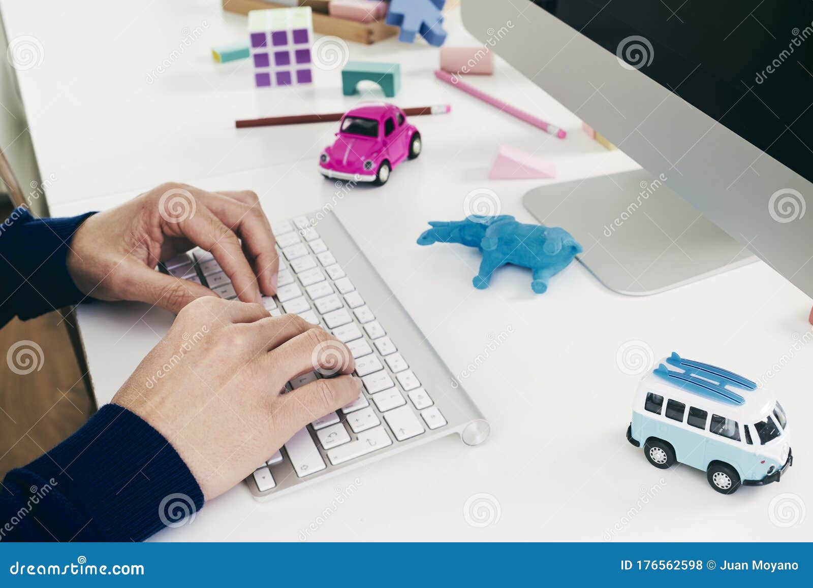 Man Using a Computer Surrounded by Toys Stock Photo - Image of position ...