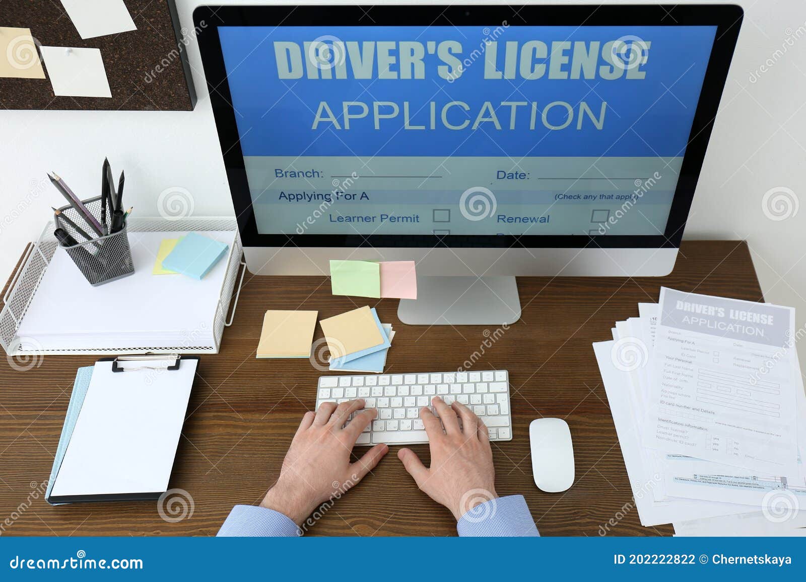 Man Using Computer To Fill Driver`s License Application Form at Table ...
