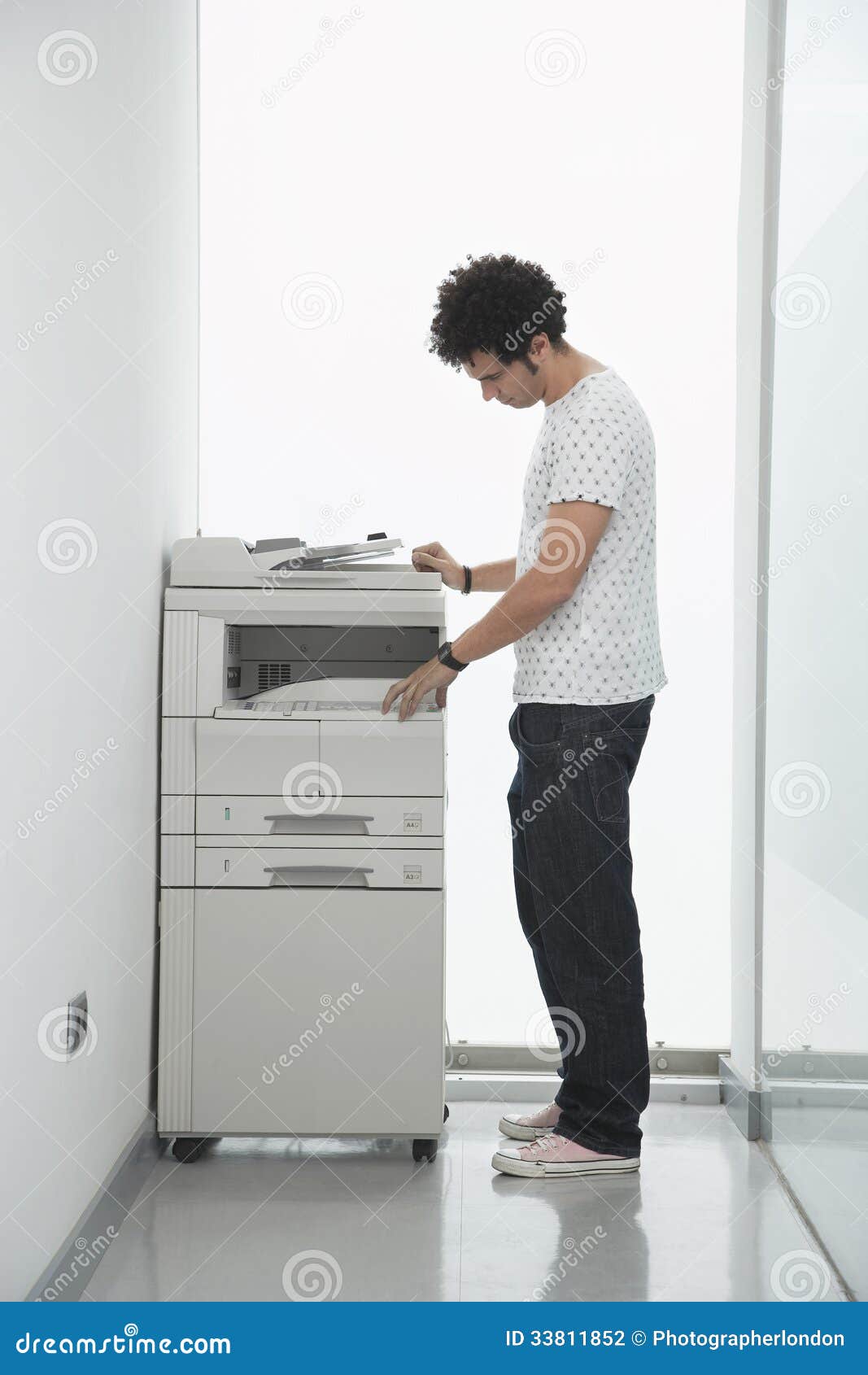 Man Using Copy Machine In Hallway Stock Photography - Image: 33811852