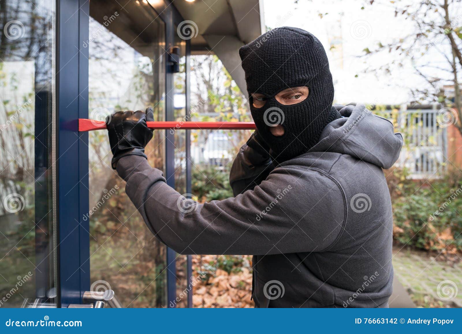 Man Using Crowbar To Open Glass Door Stock Photo - Image of people ...